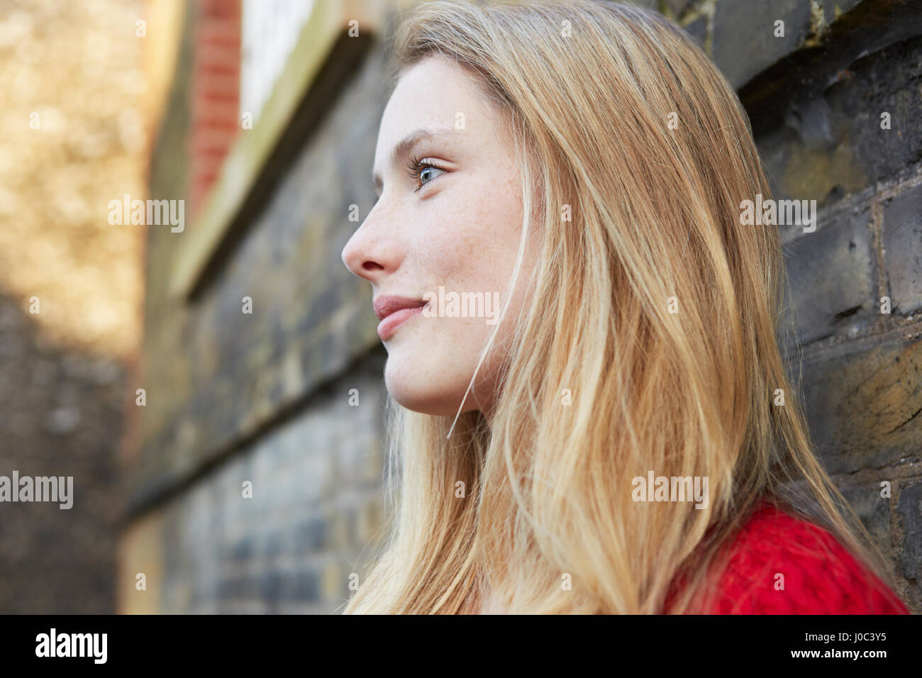 Portrait of young woman outdoors, looking away Stock Photo - Alamy