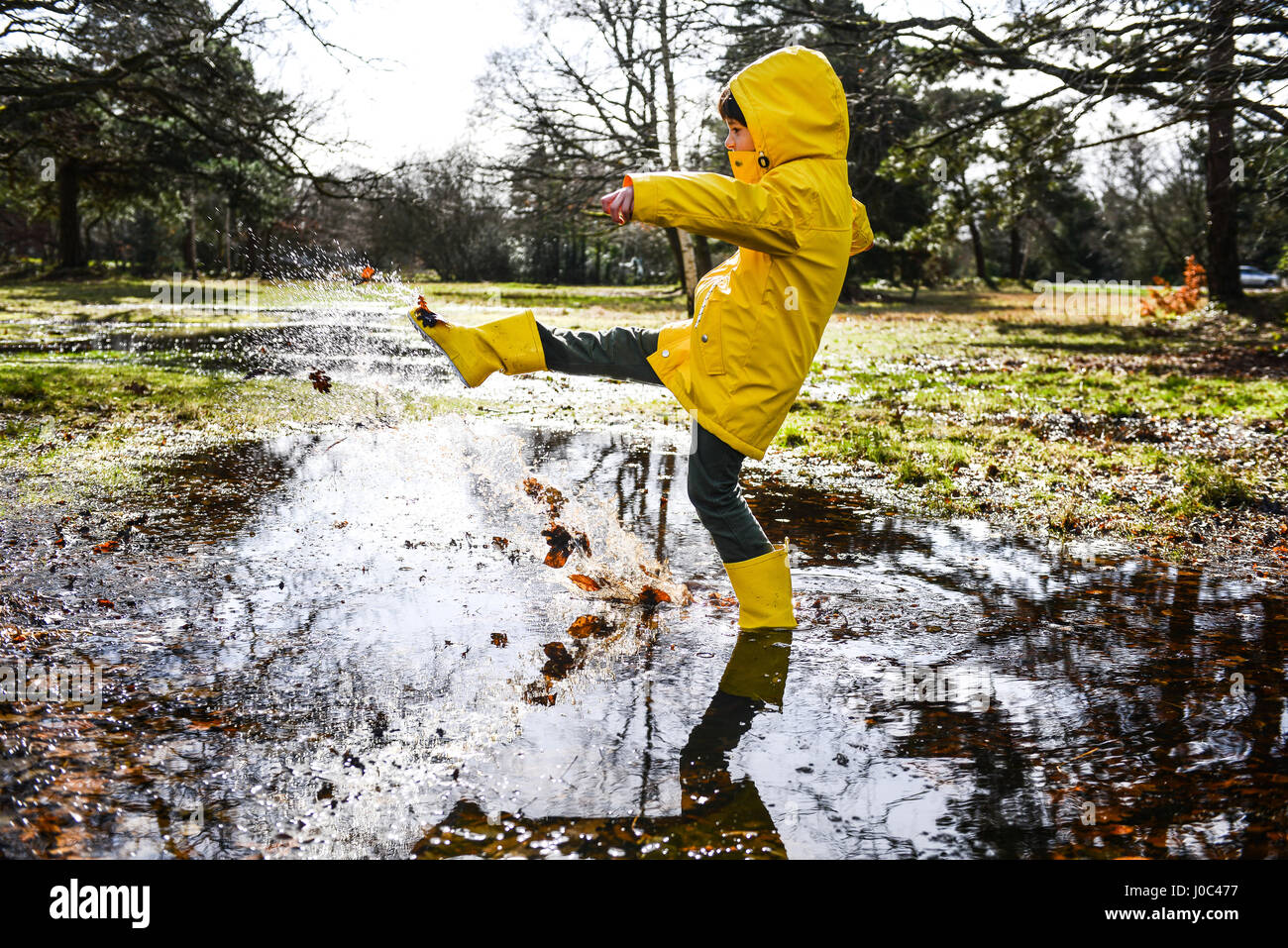 Boy puddle splashing hi-res stock photography and images - Alamy