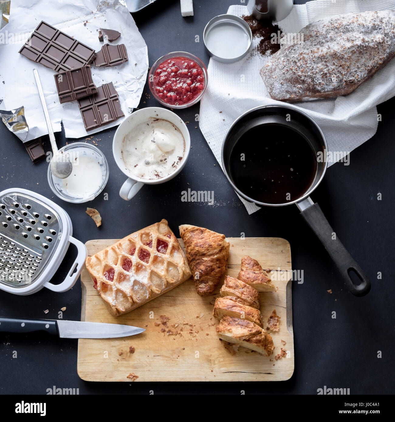 Overhead view of apple strudel, chocolate, cake and ingredients on ...