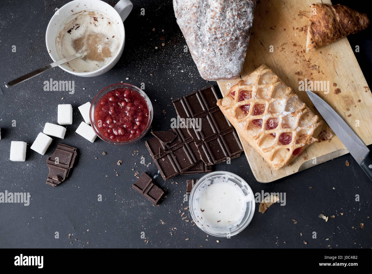 Overhead view of apple strudel, chocolate, cake and ingredients on ...