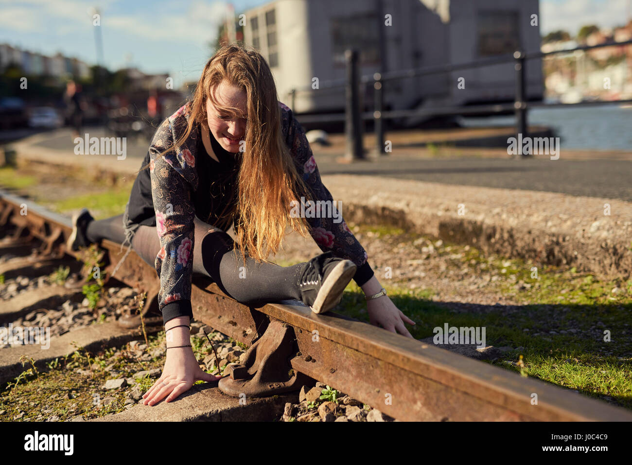 Young woman doing splits, balancing on train track, Bristol, UK Stock ...