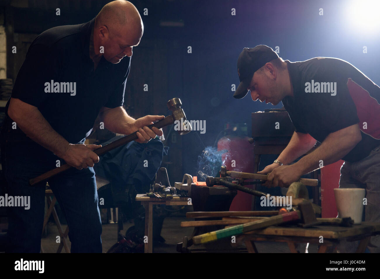 Farriers forging horseshoe on anvil Stock Photo - Alamy
