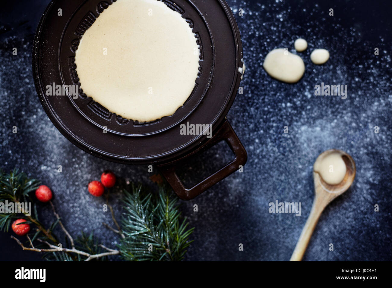 Batter on hotplate, making krumkake cookies, overhead view Stock Photo ...
