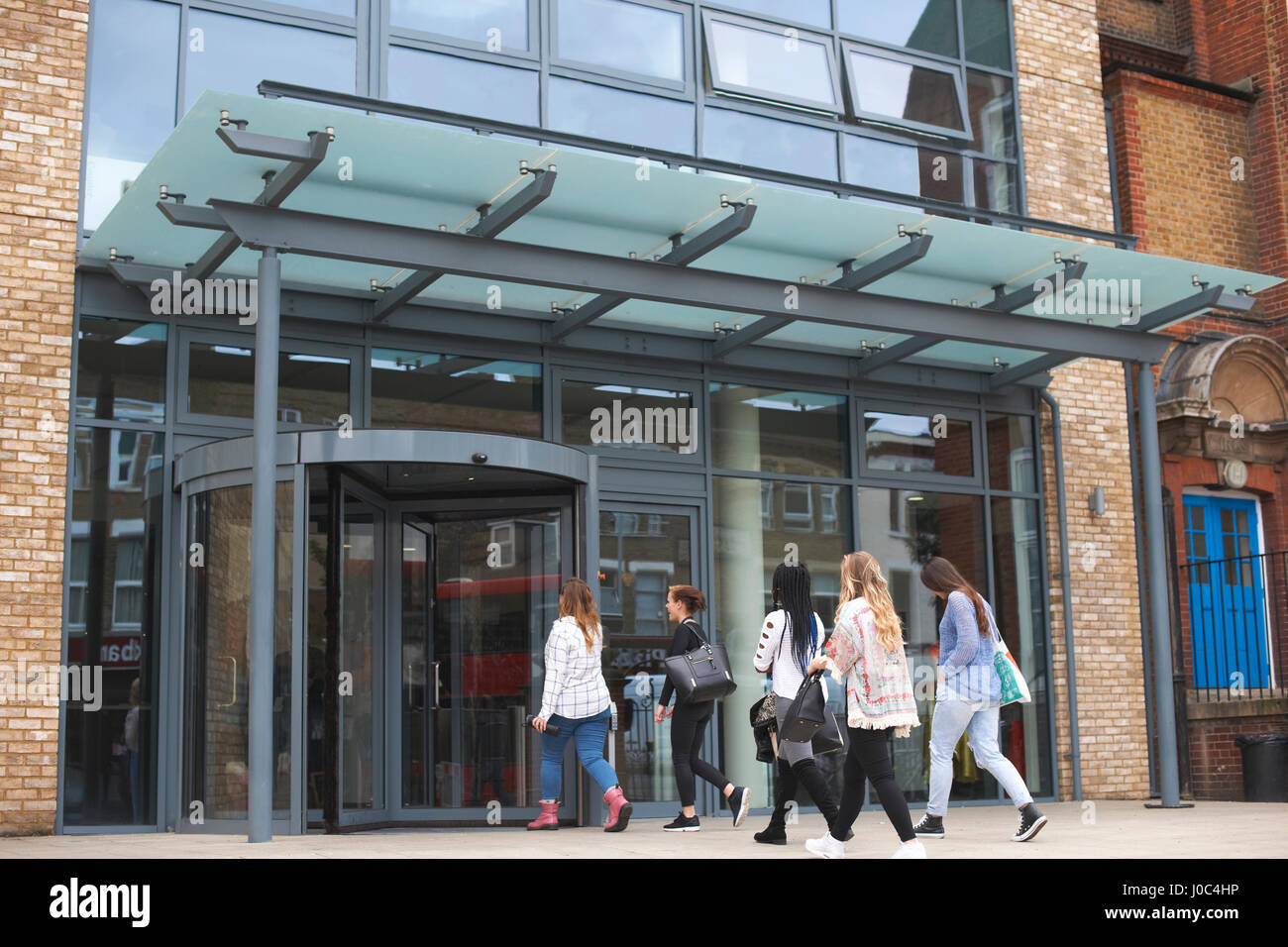 Group of students entering building, rear view Stock Photo - Alamy