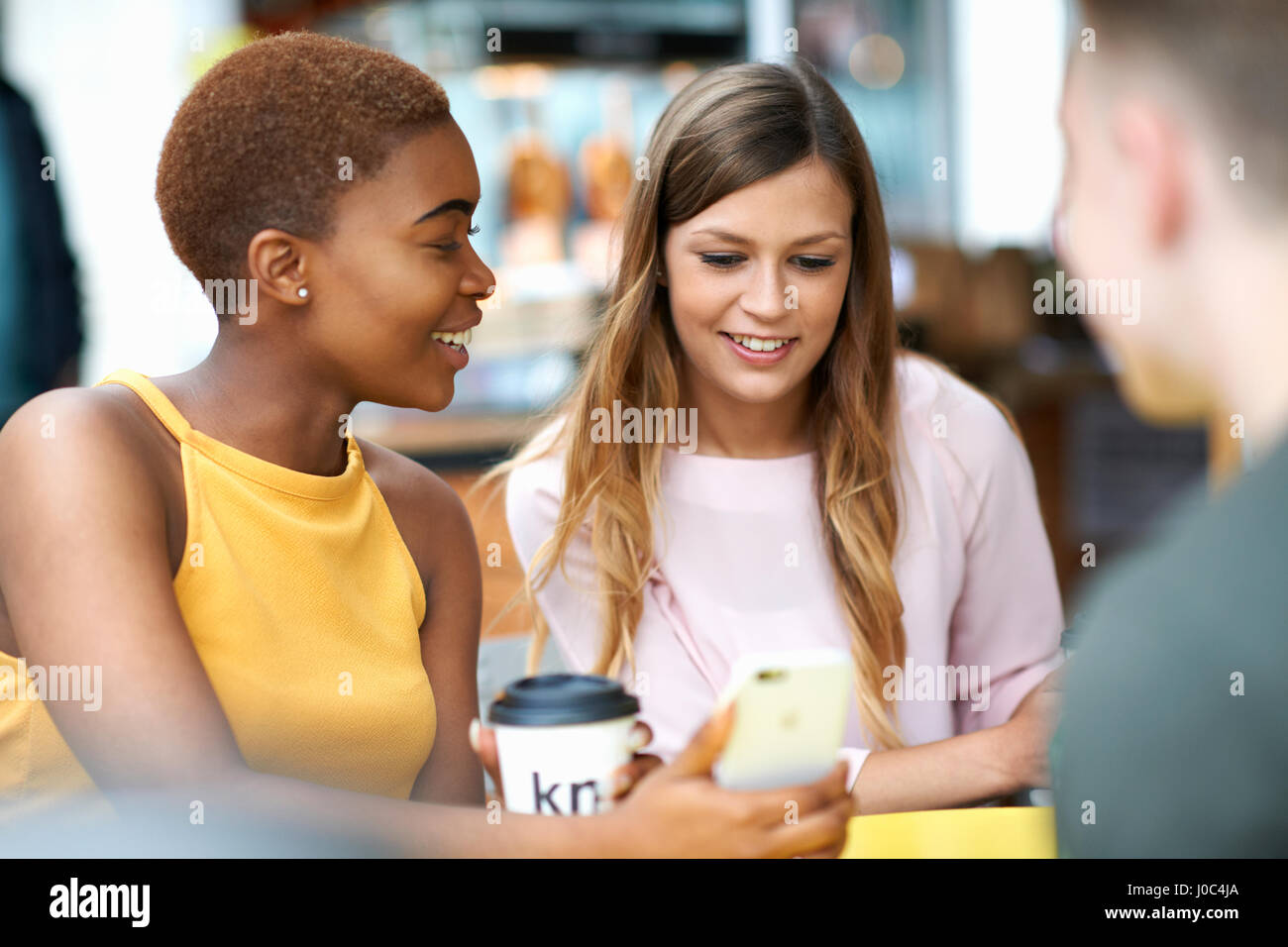 Group of friends, outdoors, looking at smartphone Stock Photo - Alamy