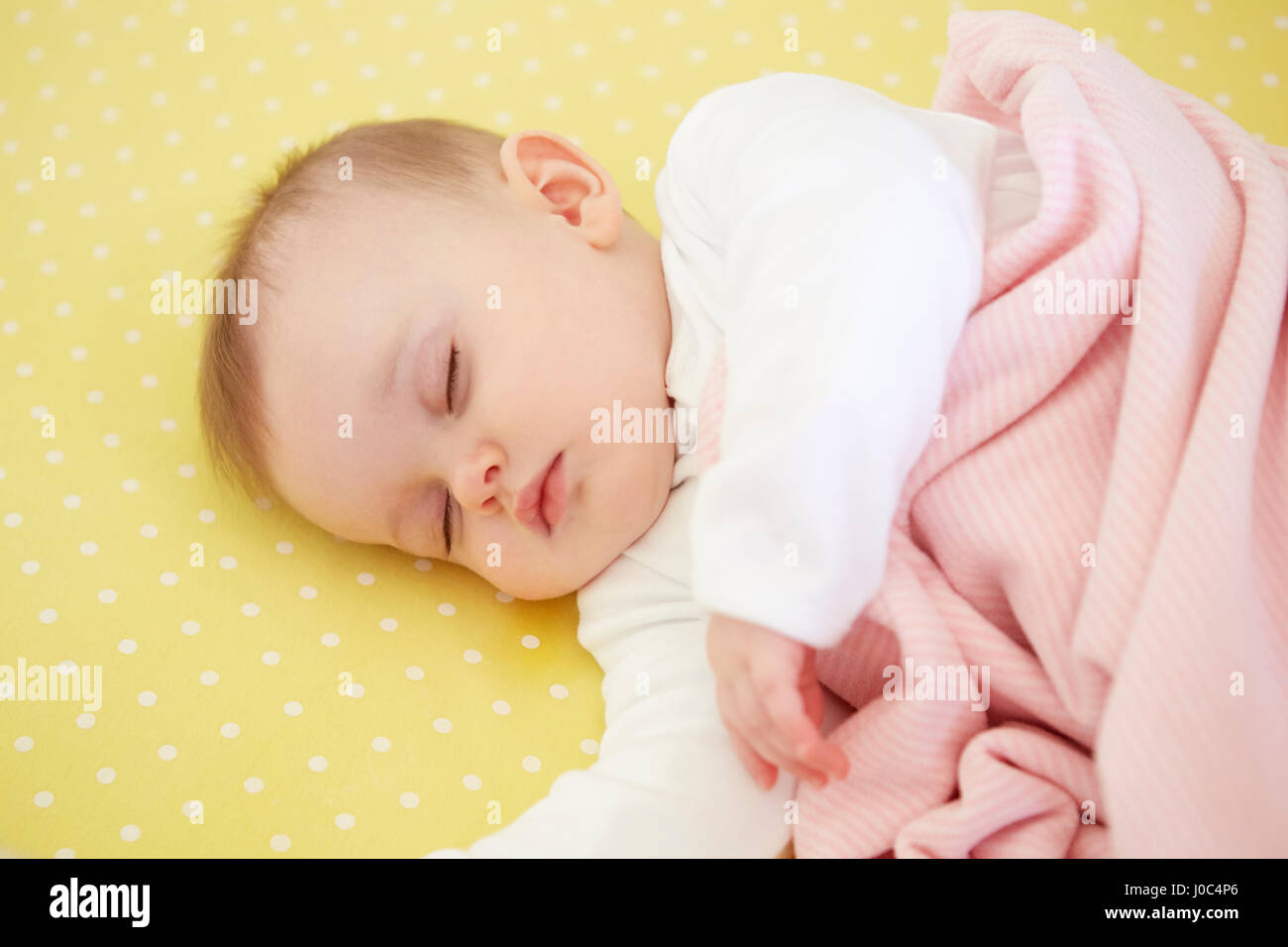 Baby girl sleeping in crib hi-res stock photography and images - Alamy