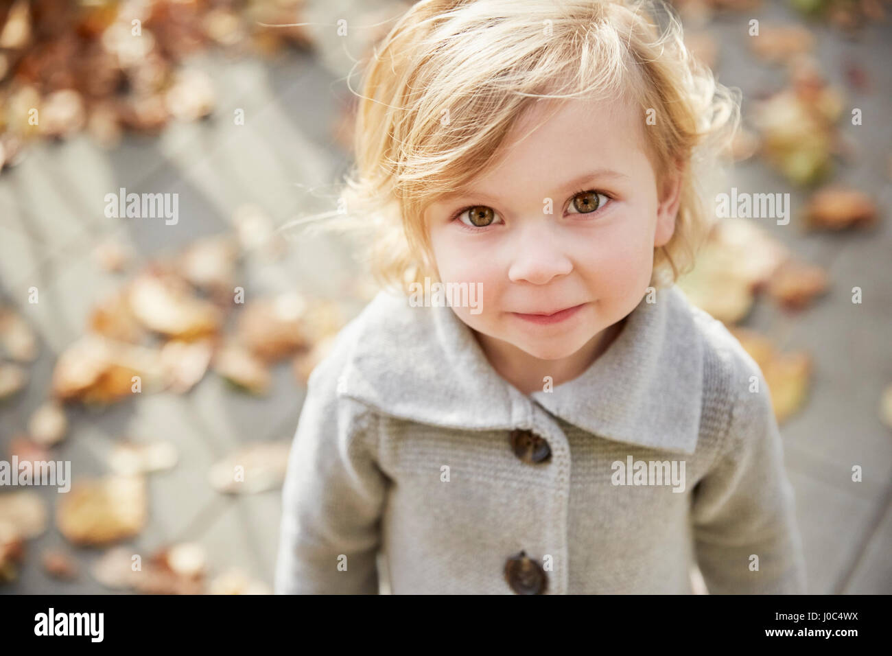 Portrait of cute girl looking at camera Stock Photo - Alamy