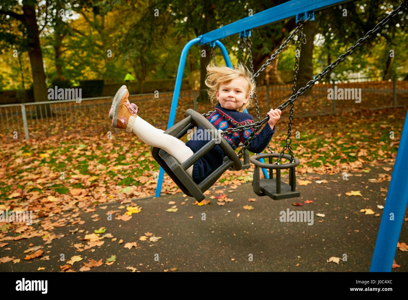Child swinging side hi-res stock photography and images - Alamy