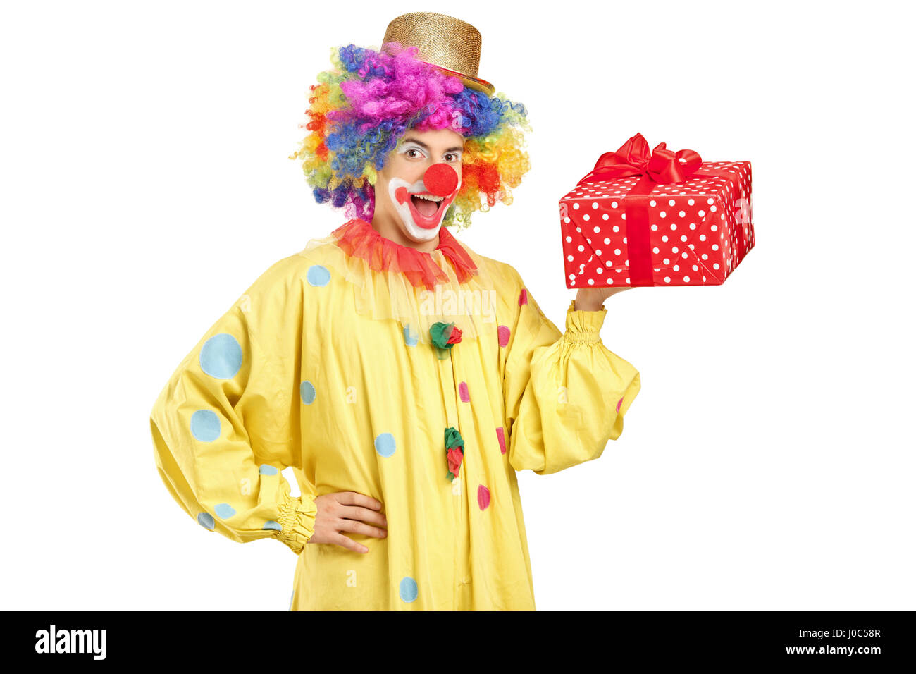 Joyful clown with a present isolated on white background Stock Photo ...