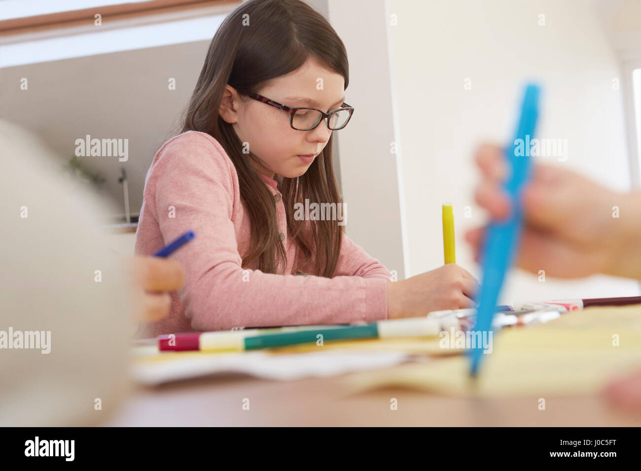 Girl drawing at table Stock Photo - Alamy