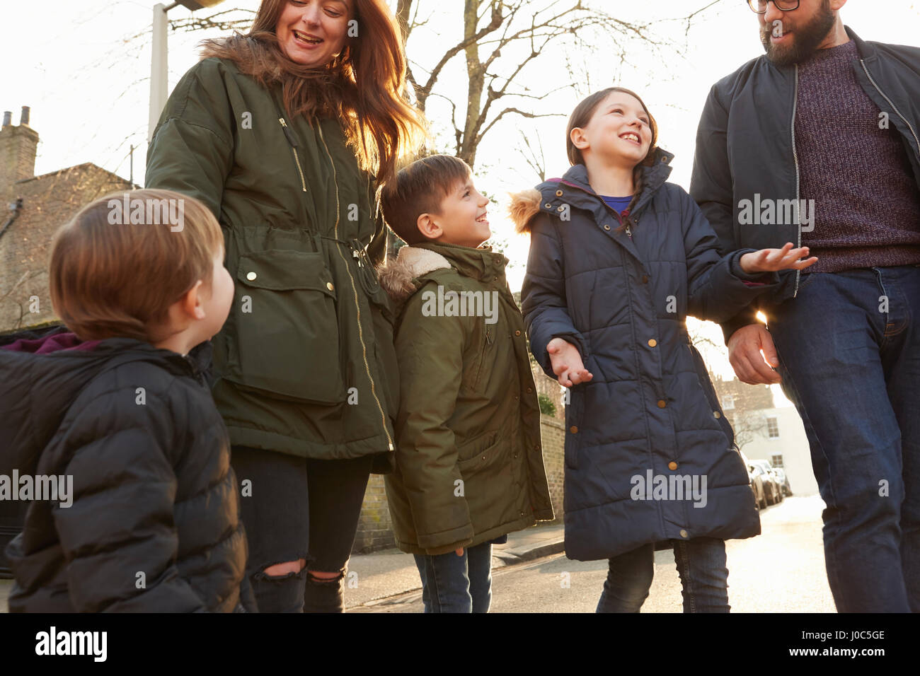 Mid adult couple and three children strolling on street Stock Photo - Alamy