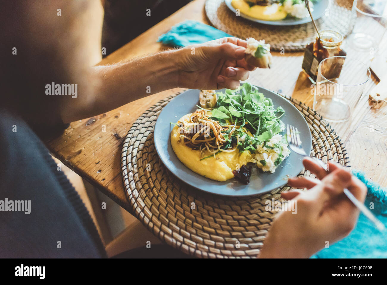 Over shoulder view of man eating omelette lunch at table Stock Photo ...