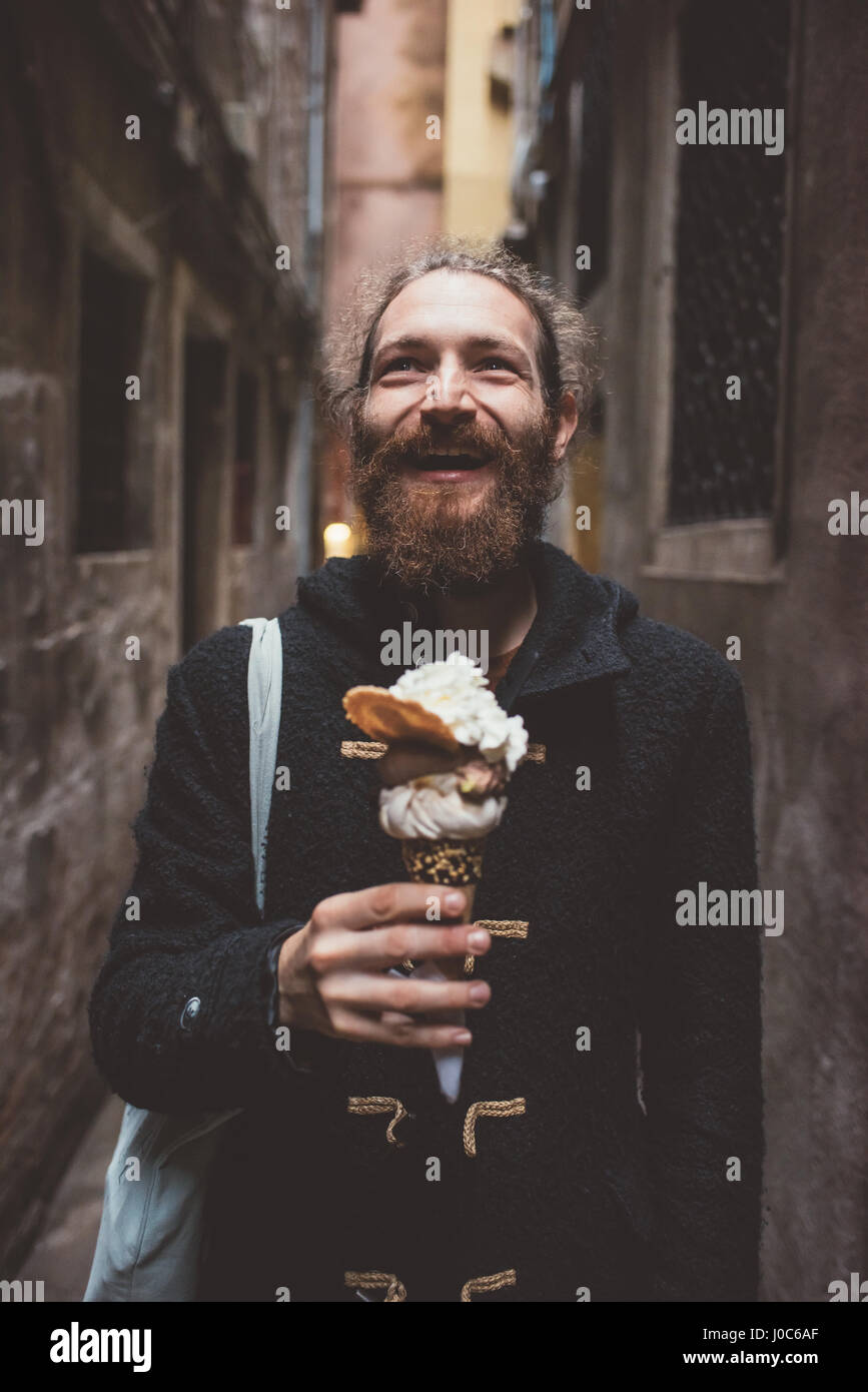 Mid adult man with gelato in dark alley, Venice, Italy Stock Photo - Alamy