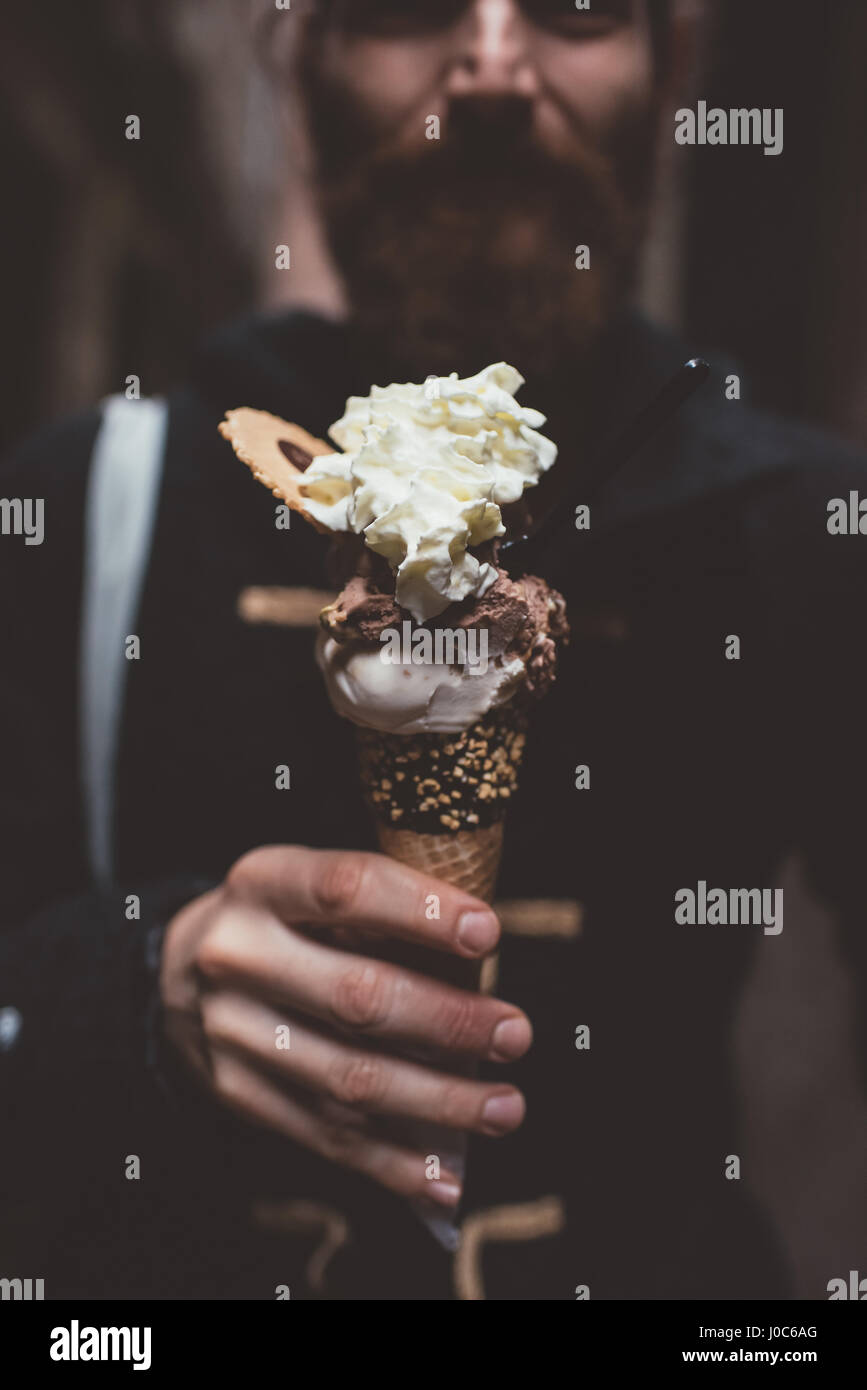 Hand of man holding gelato in dark alley, Venice, Italy Stock Photo - Alamy