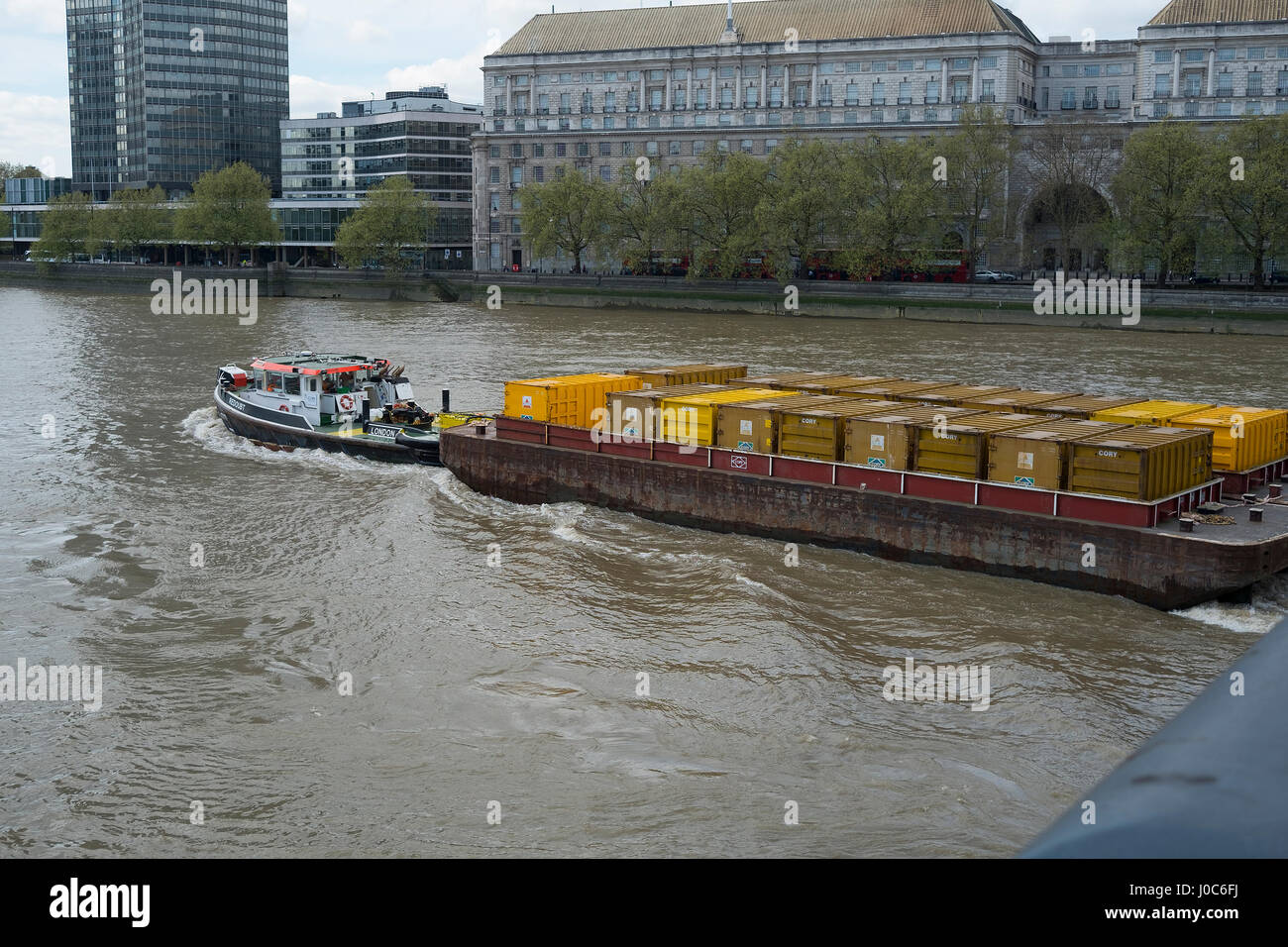 Large barge with containers moves upstream at Lambeth on the river ...
