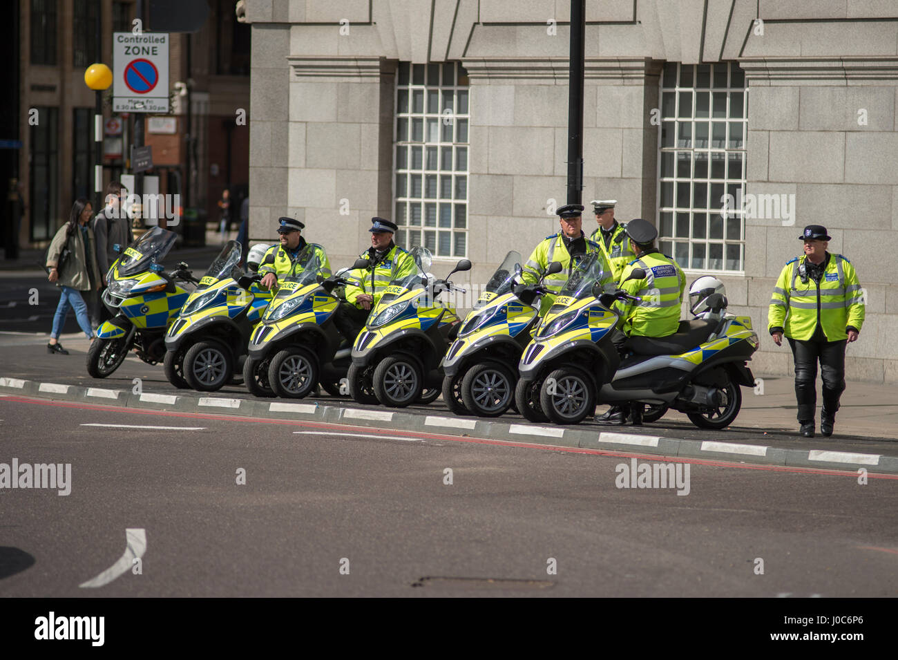Police community support officers parked by roadside with three wheel ...