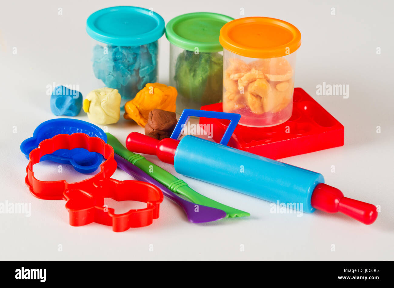 Colorful plasticine and tools on white background Stock Photo - Alamy