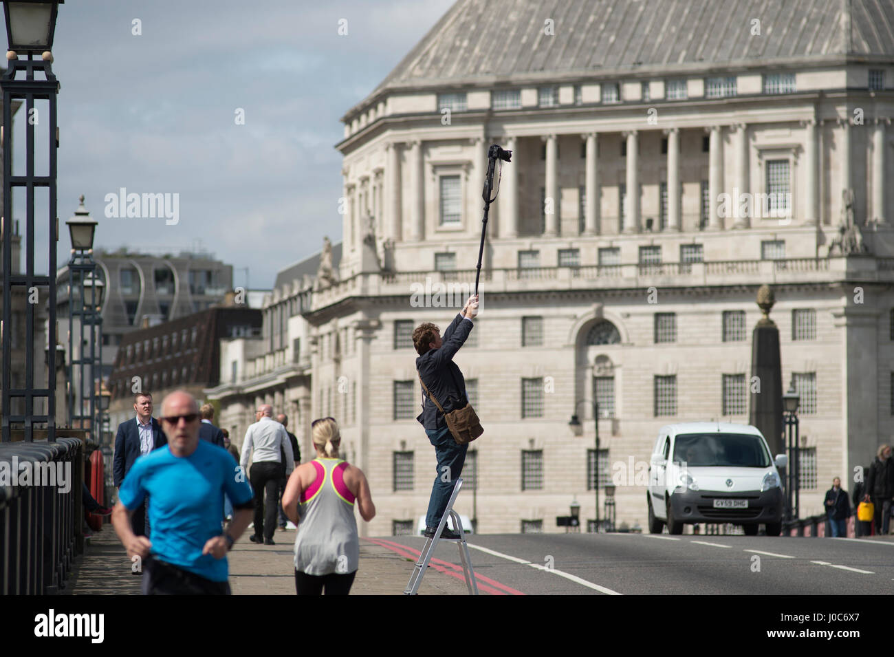 Press photographer with ladder and monopod on Lambeth Bridge, London ...