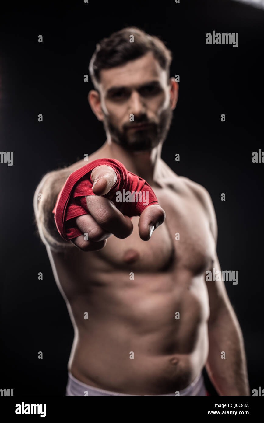 Young muscular boxer pointing at camera with wrapping hand Stock Photo ...
