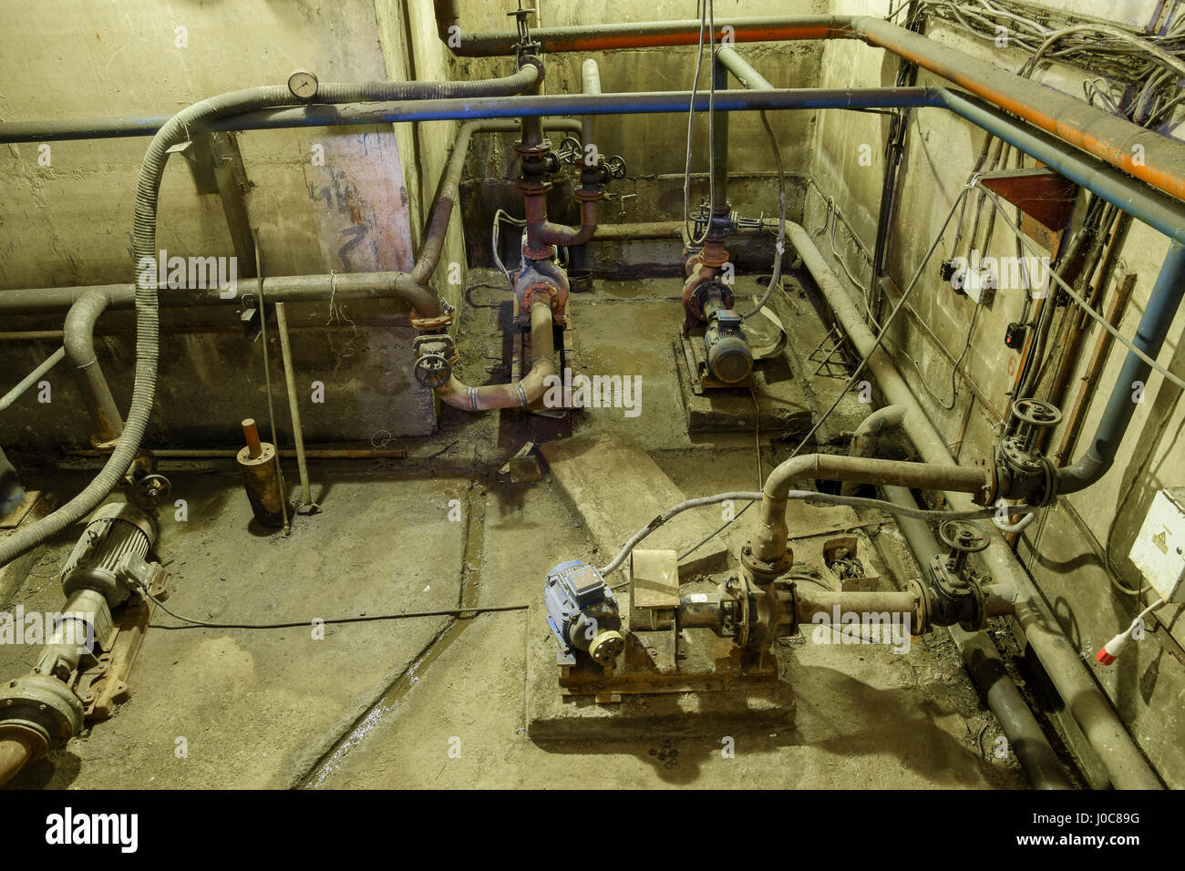 Basement of a water pumping station. Abandoned post-apocalyptic view of ...