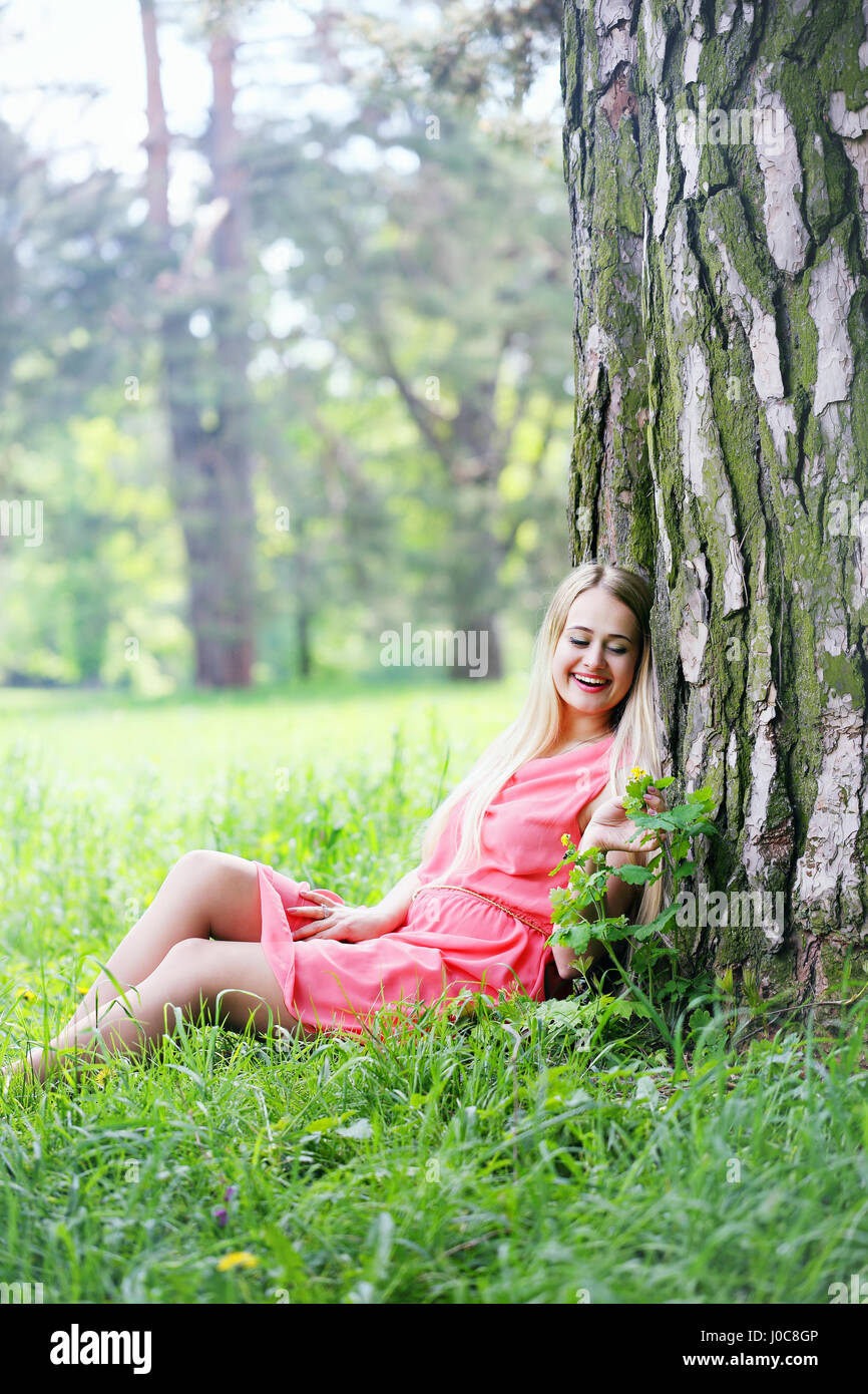 woman sitting under a tree Stock Photo - Alamy