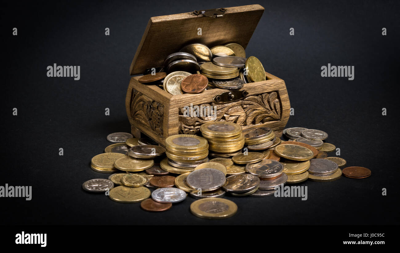Little wooden chest filled up with coins bringing good fortune Stock ...