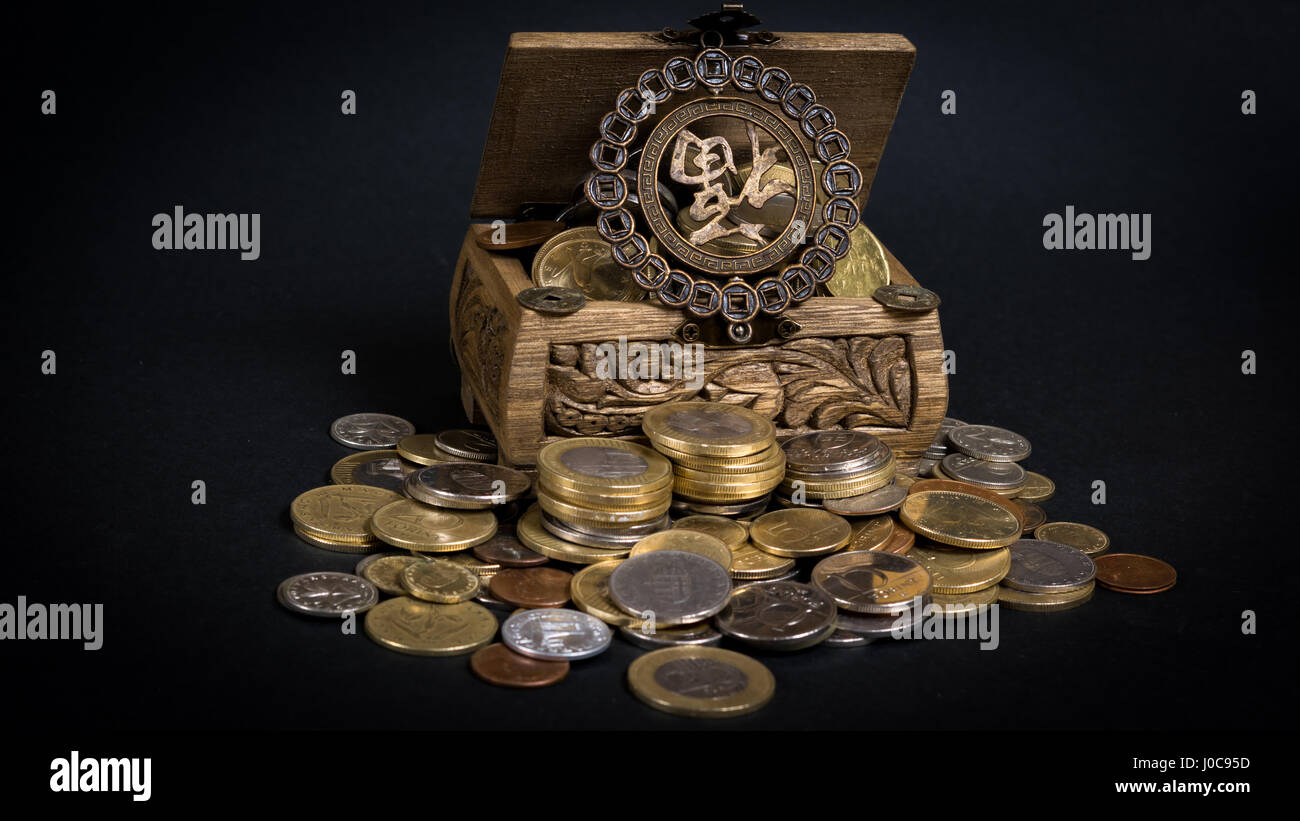 Little wooden chest filled up with coins bringing good fortune Stock ...