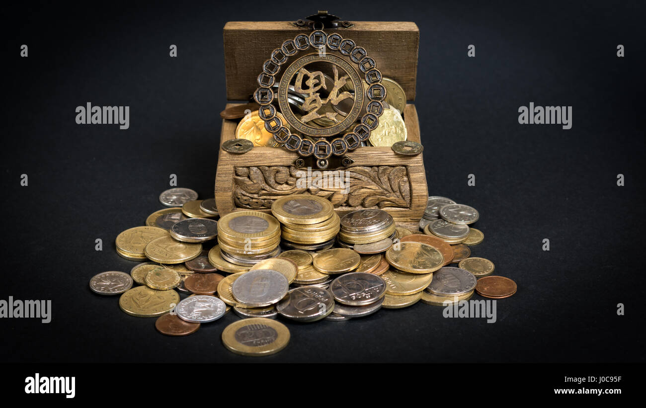 Little wooden chest filled up with coins bringing good fortune Stock ...