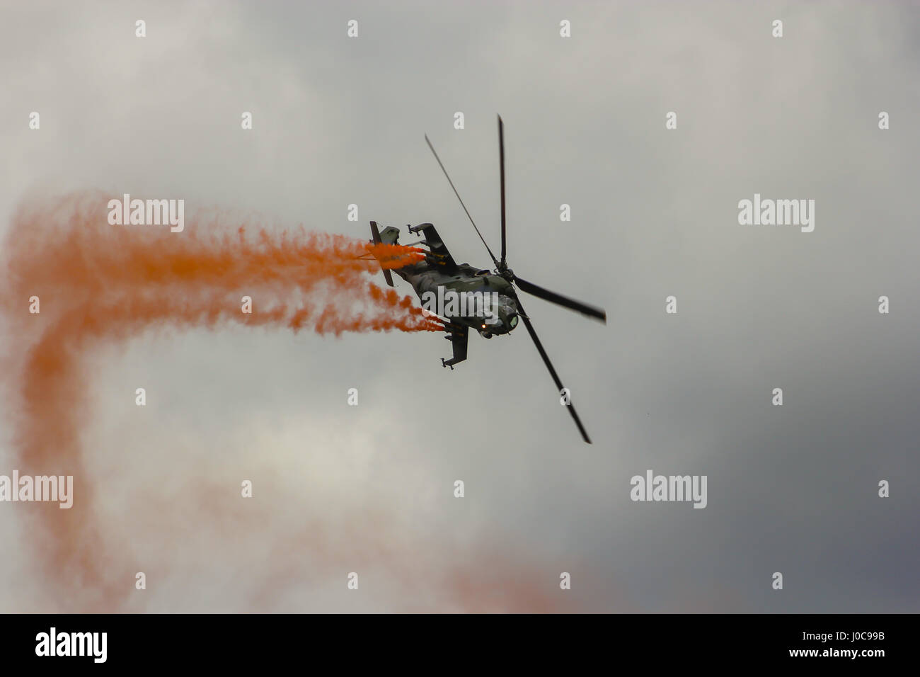 Military helicopter in flight, smoke Stock Photo - Alamy
