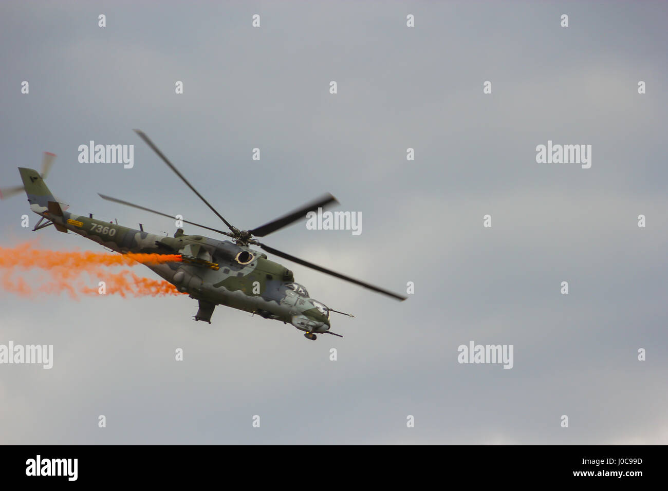 Military helicopter in flight, smoke Stock Photo - Alamy