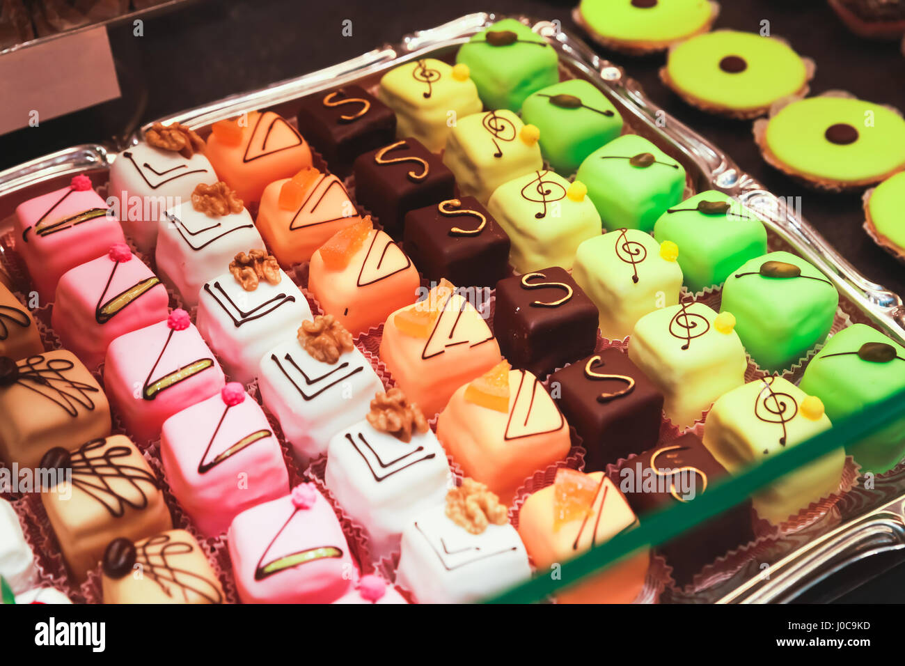 Colorful chocolate candies lay on a market counter, closeup photo with ...
