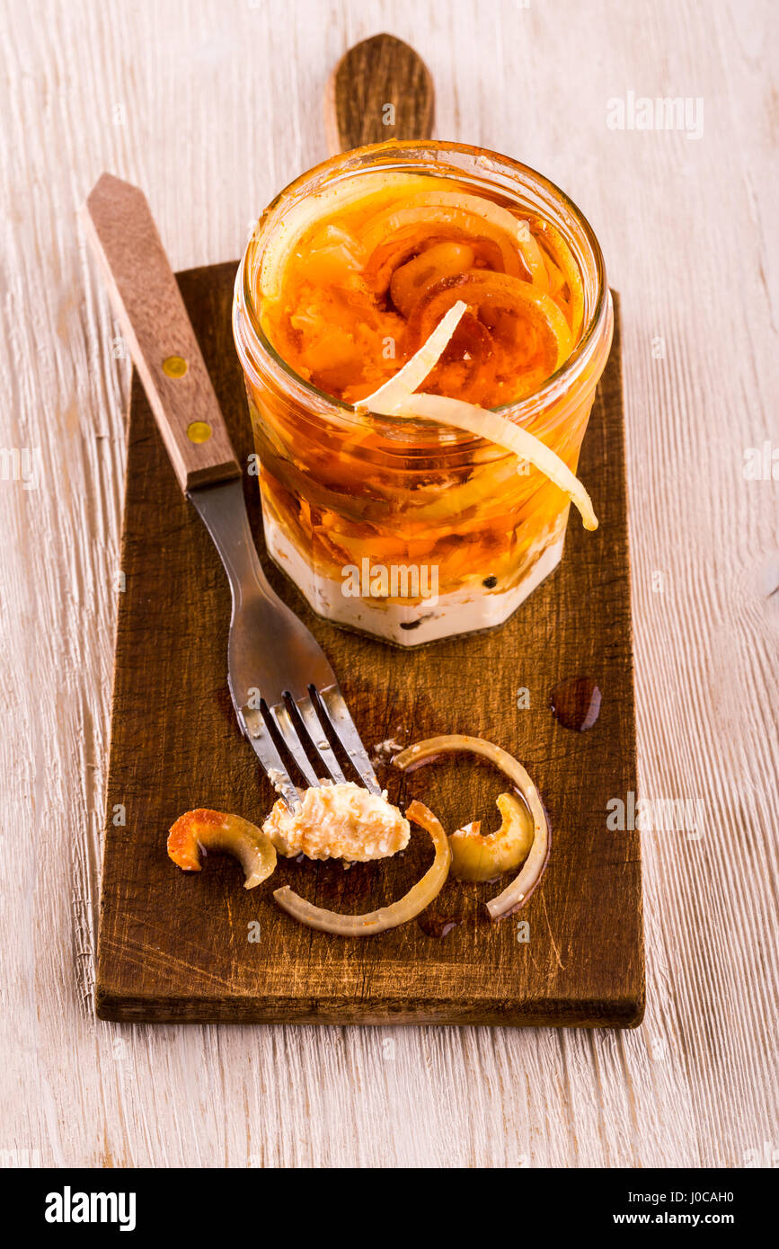 Vertical photo of single glass jar which is fully filled by pickled ...