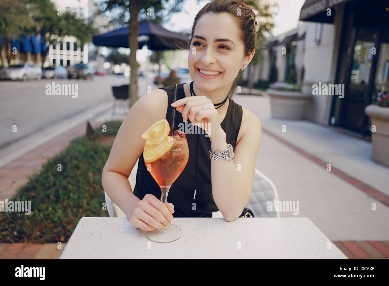beautiful young girl enjoying a delicious cocktail Stock Photo - Alamy