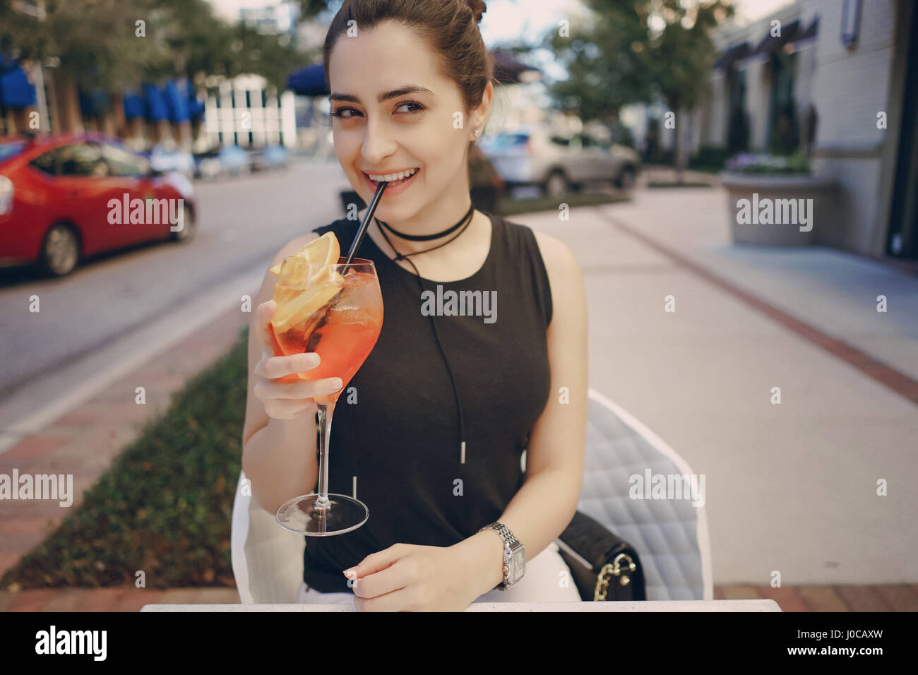 beautiful young girl enjoying a delicious cocktail Stock Photo - Alamy