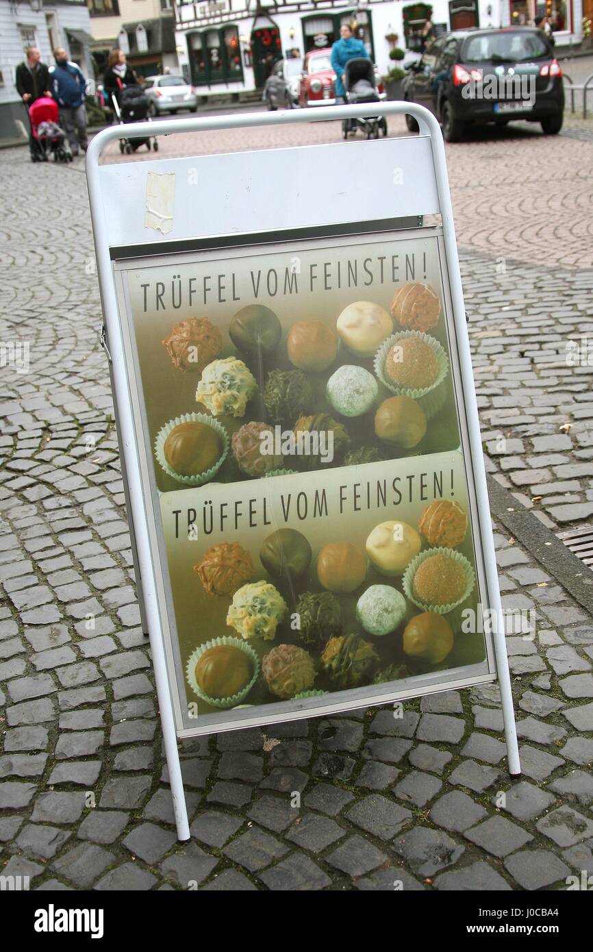 Advertising board on a street outside a sweet shop business in the ...