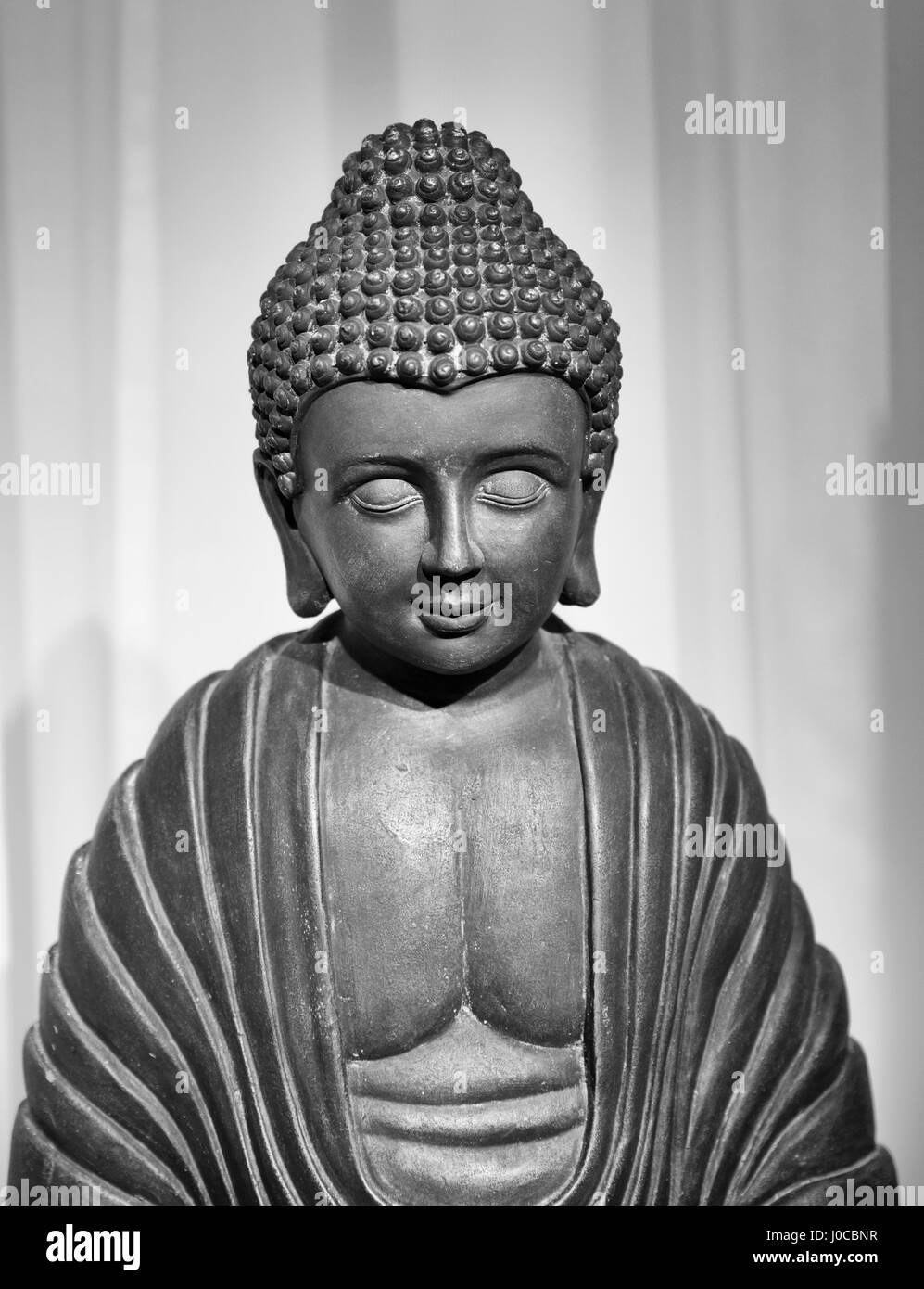 Stone statue of Budha with drape background Stock Photo - Alamy