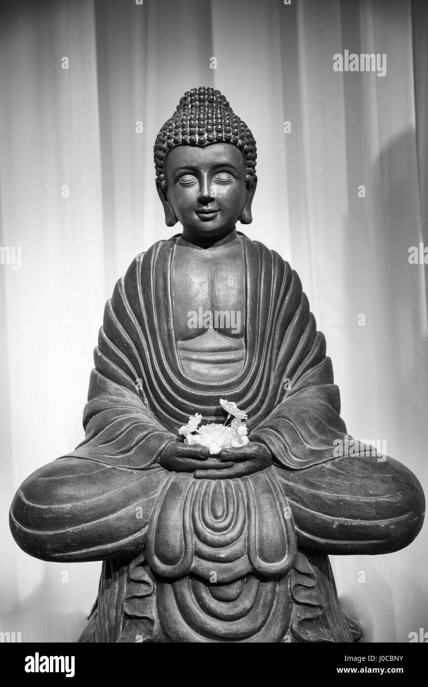 Stone statue of Budha with drape background Stock Photo - Alamy