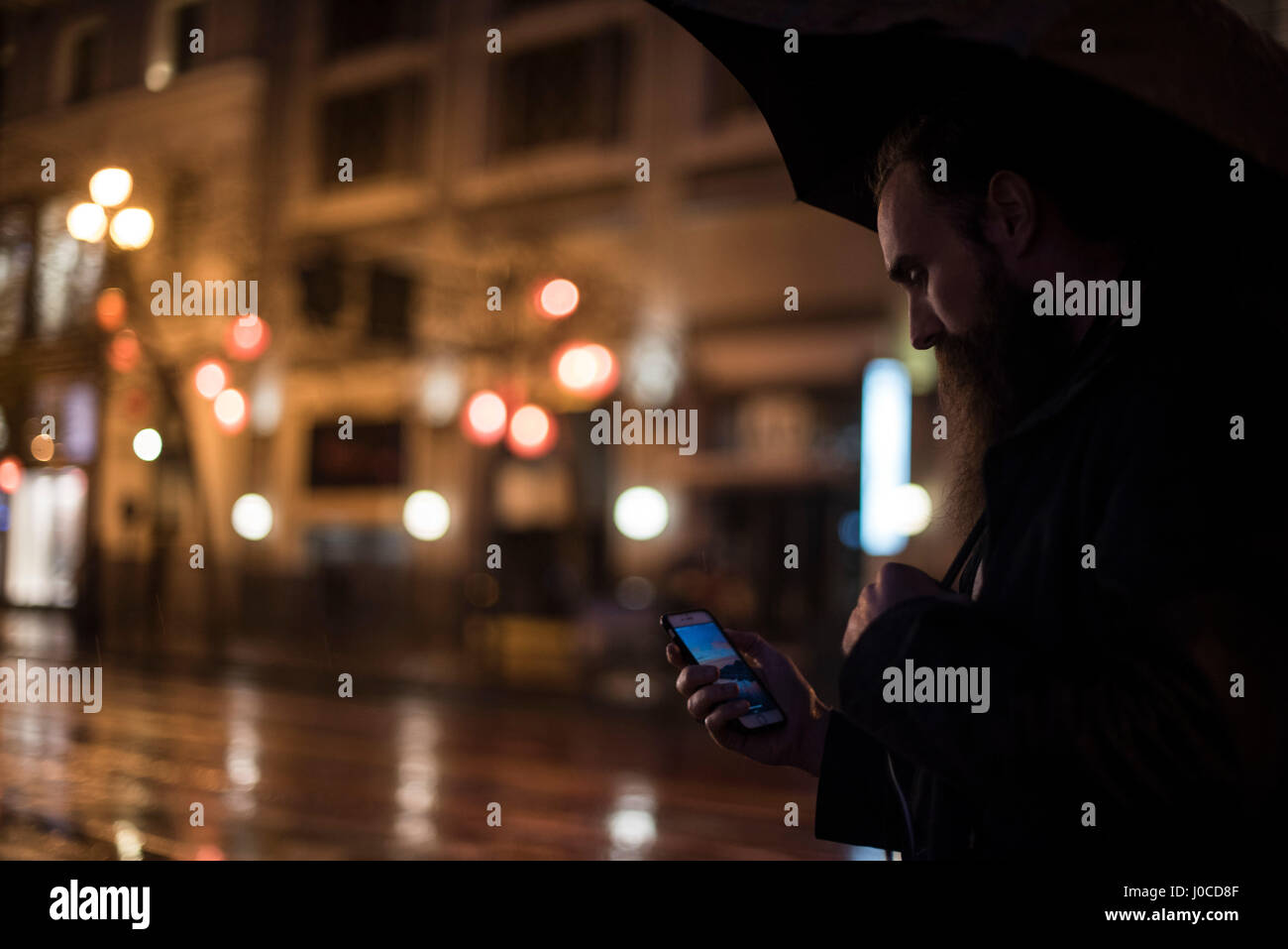 Person using smartphone in rain hi-res stock photography and images - Alamy
