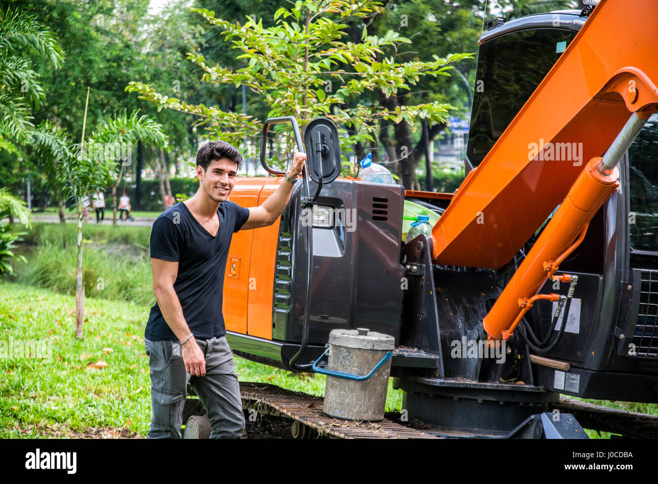 Young male near constructing machine Stock Photo - Alamy