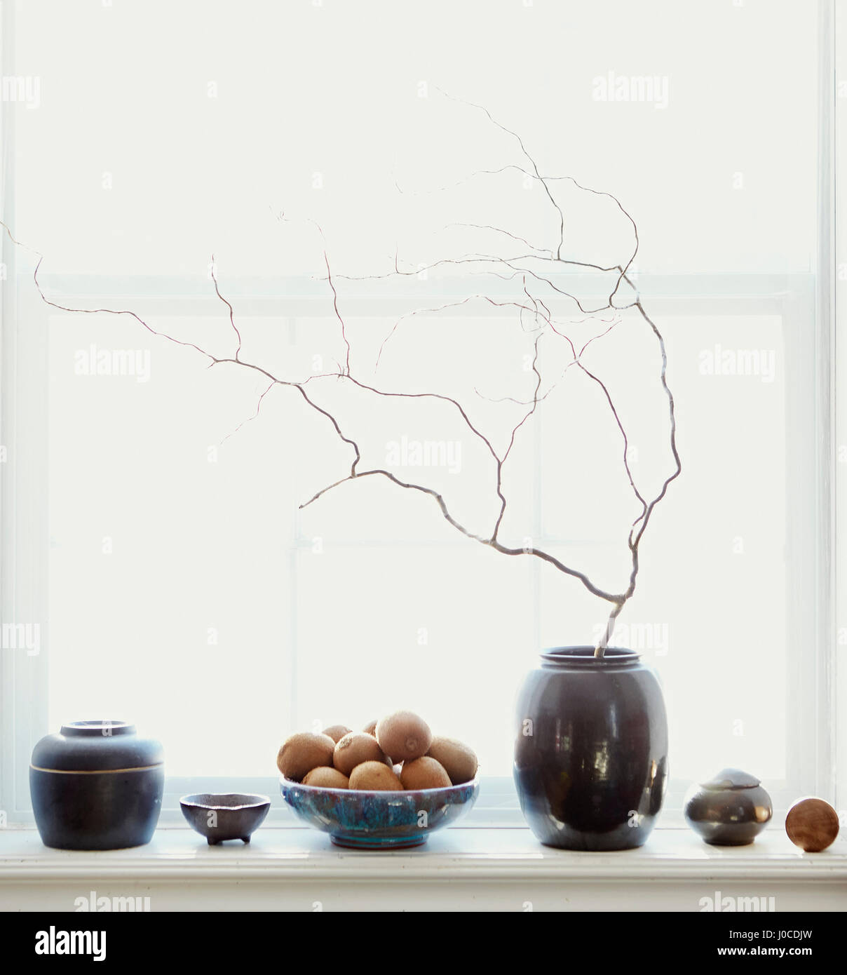 Composition of fruits and vases by window Stock Photo - Alamy