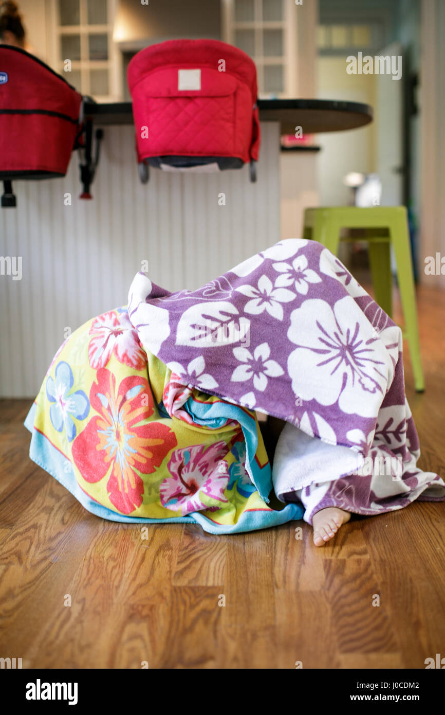 Child hiding under blanket on floor hi-res stock photography and images ...