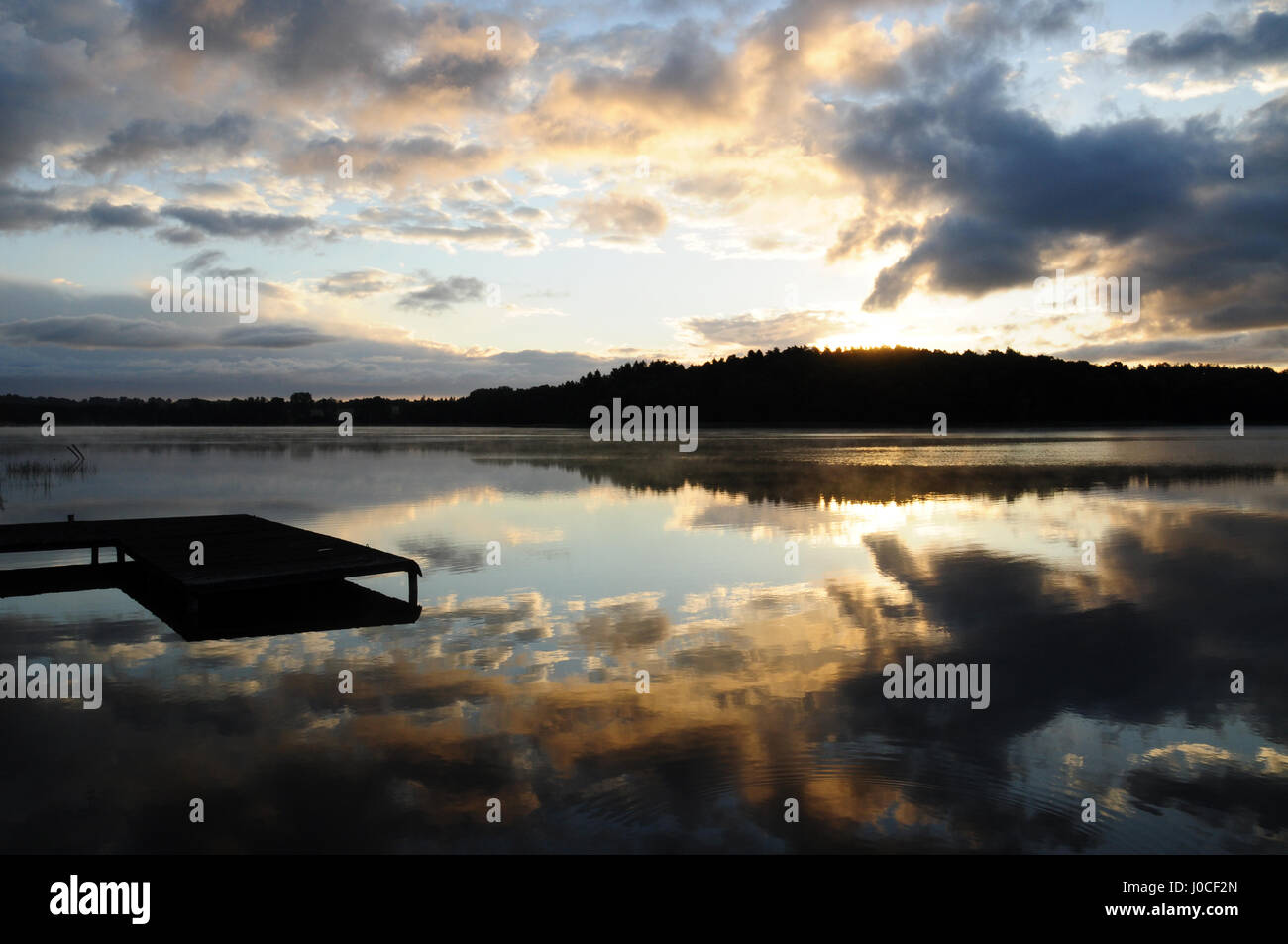 Beautiful summer sunrise over the lake in Polish countryside of Mazury ...
