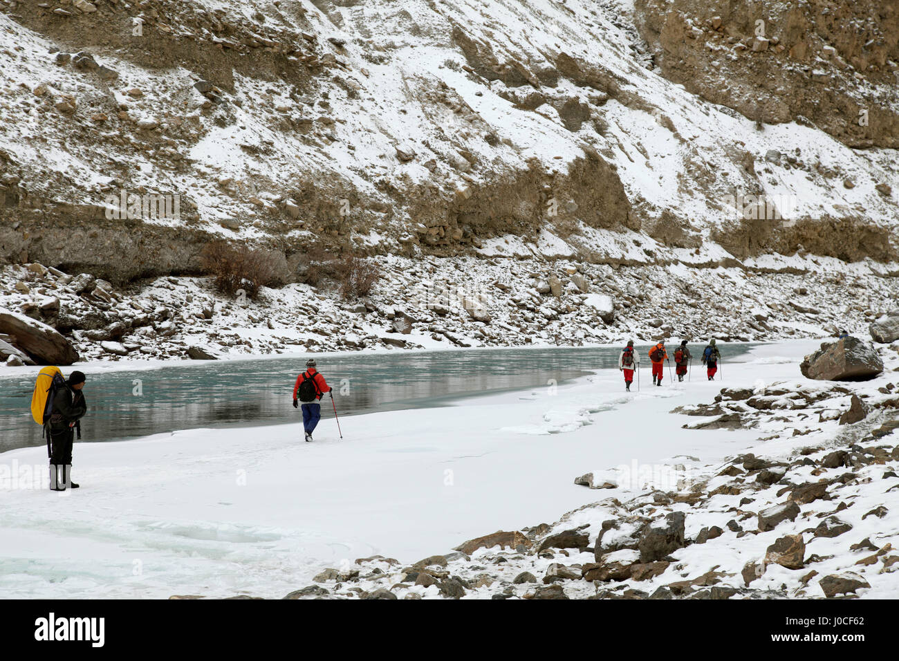 Trekkers walking on frozen river, chadar trek, ladakh, jammu and ...