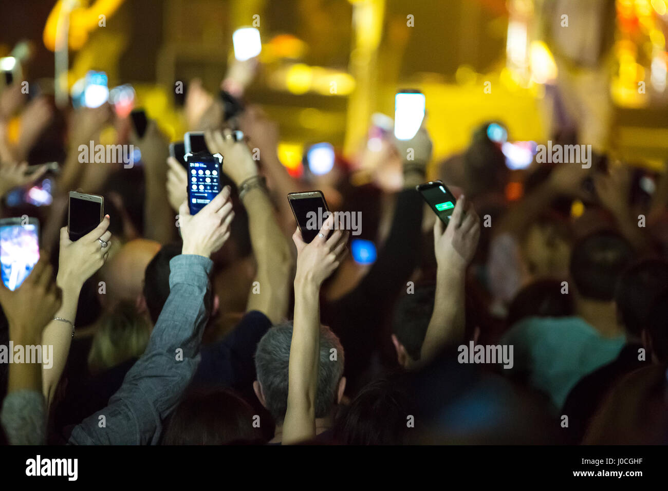 Crowd at concert and blurred stage lights . Close up of photographing ...