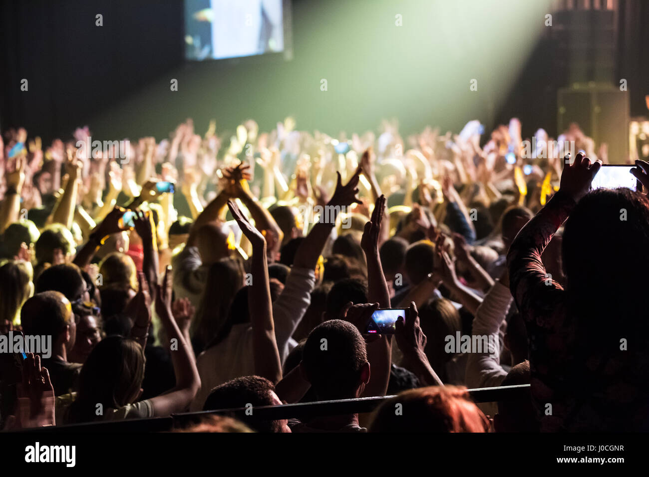 Crowd at concert and blurred stage lights . Close up of photographing ...