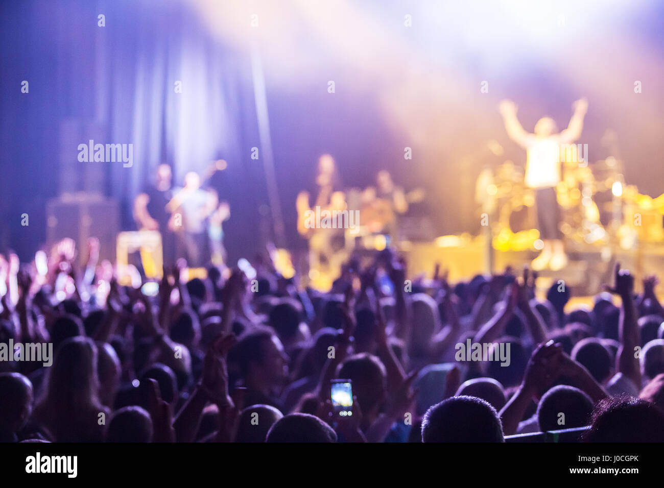 Crowd at concert and blurred stage lights . Close up of photographing ...