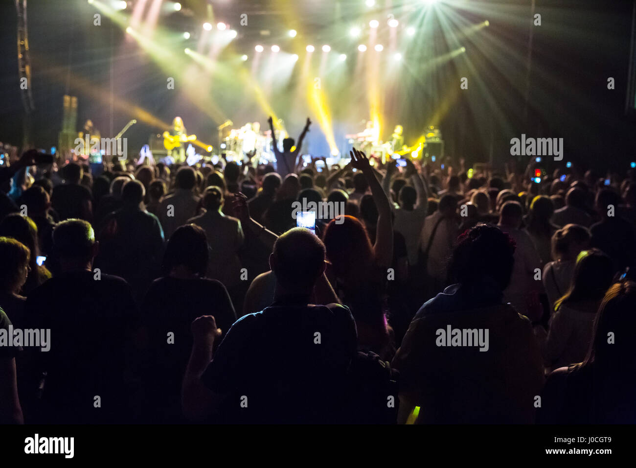 Crowd at concert and blurred stage lights . Close up of photographing ...