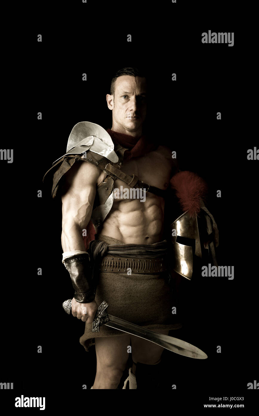 Ancient warrior or Gladiator posing over a dark background Stock Photo ...