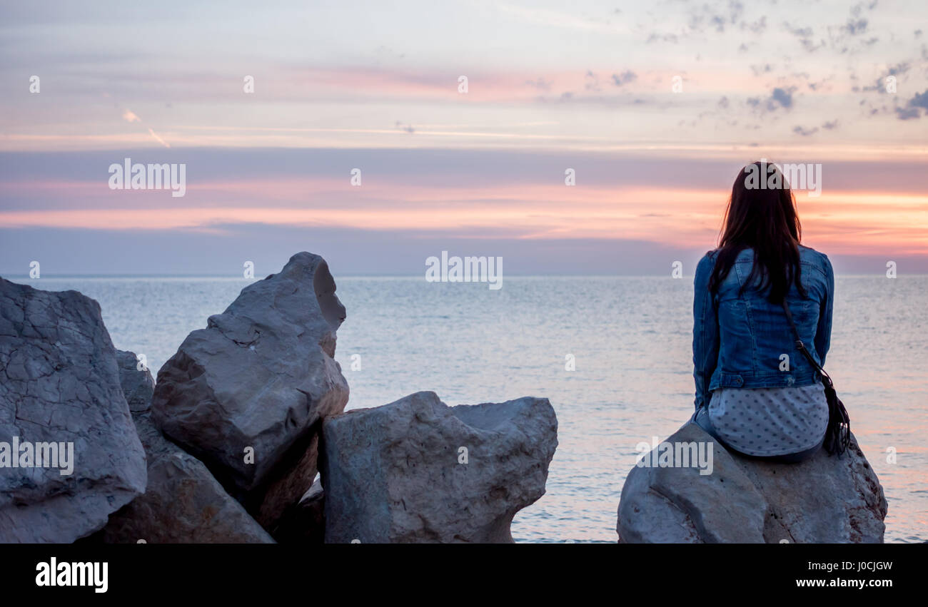 Person looking over water at sunset hi-res stock photography and images ...