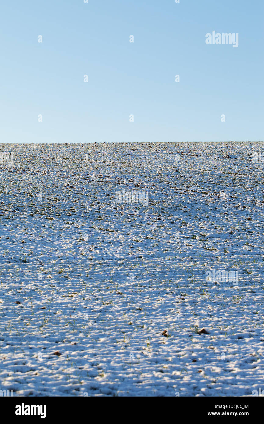 Snow, land and blue sky Stock Photo - Alamy